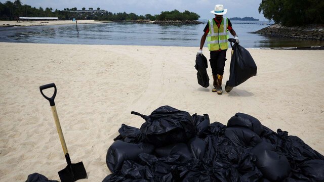 In pics: Singapore shuts beaches of Sentosa resort island after oil ...