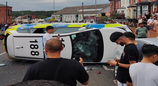 IN PICS: Bus set on fire, police car overturned as riot erupts in Leeds ...