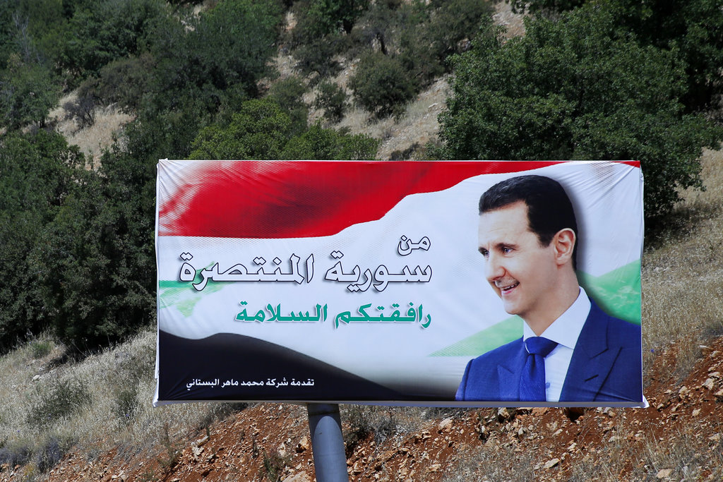 Assad's victory posters crowd Damascus streets - cnbctv18.com